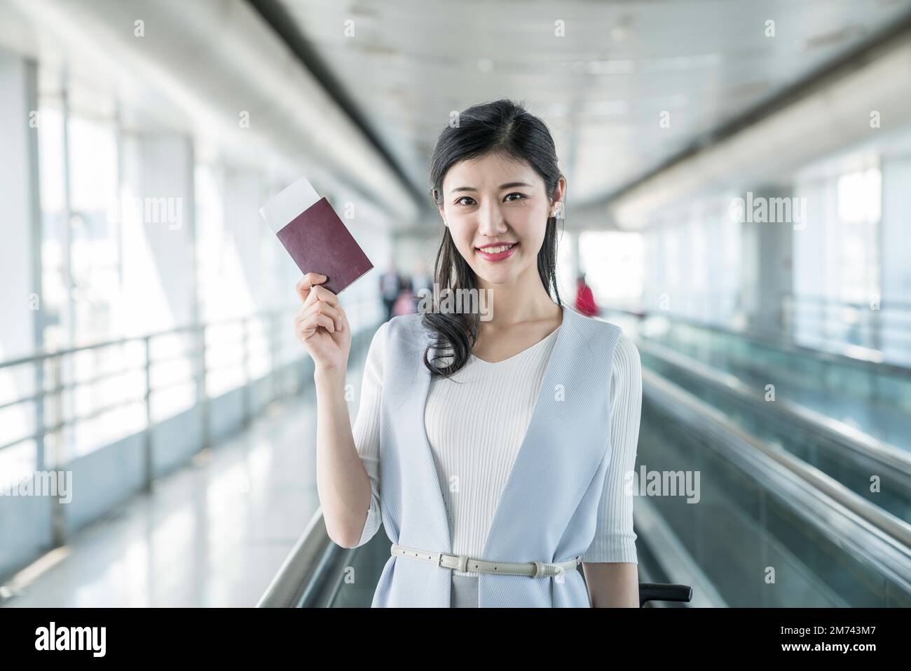 A young business woman holding a passport Stock Photo - Alamy