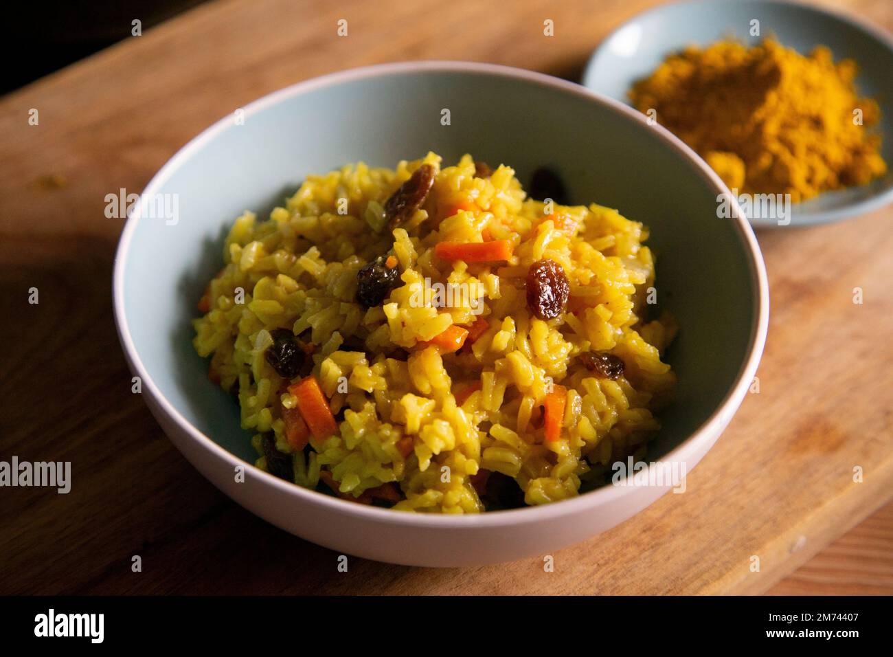 Fried rice cooked with curry, raisins and carrot Stock Photo - Alamy