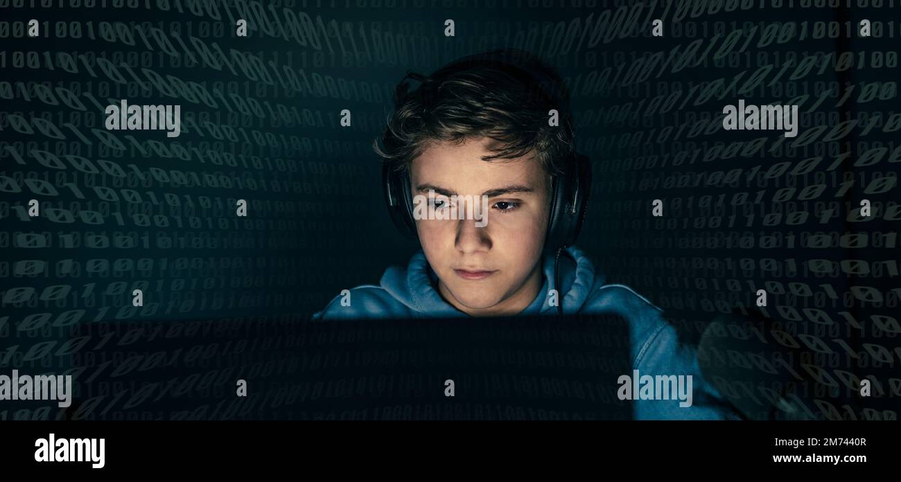 Teenager focused on computer display. Green numbers on background ...