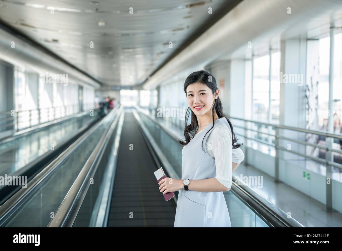 The elevator mobile young business lady in the airport Stock Photo - Alamy