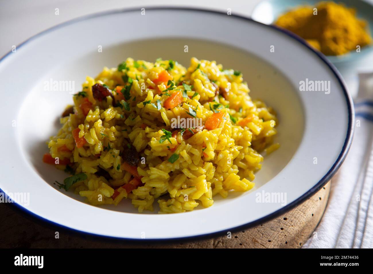 Fried rice cooked with curry, raisins and carrot Stock Photo - Alamy