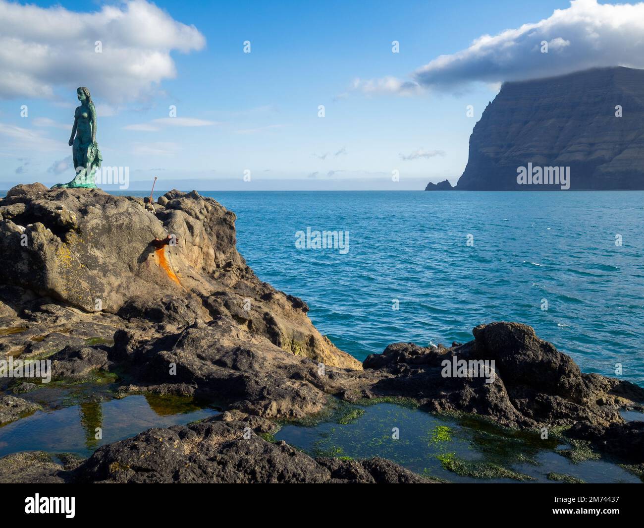 Kópakonan, the seal woman, statue over the rocks by the Kalsoyarfjørður ...