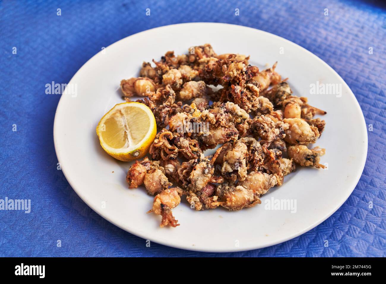 Plate of fried chopitos on paper surface Stock Photo - Alamy