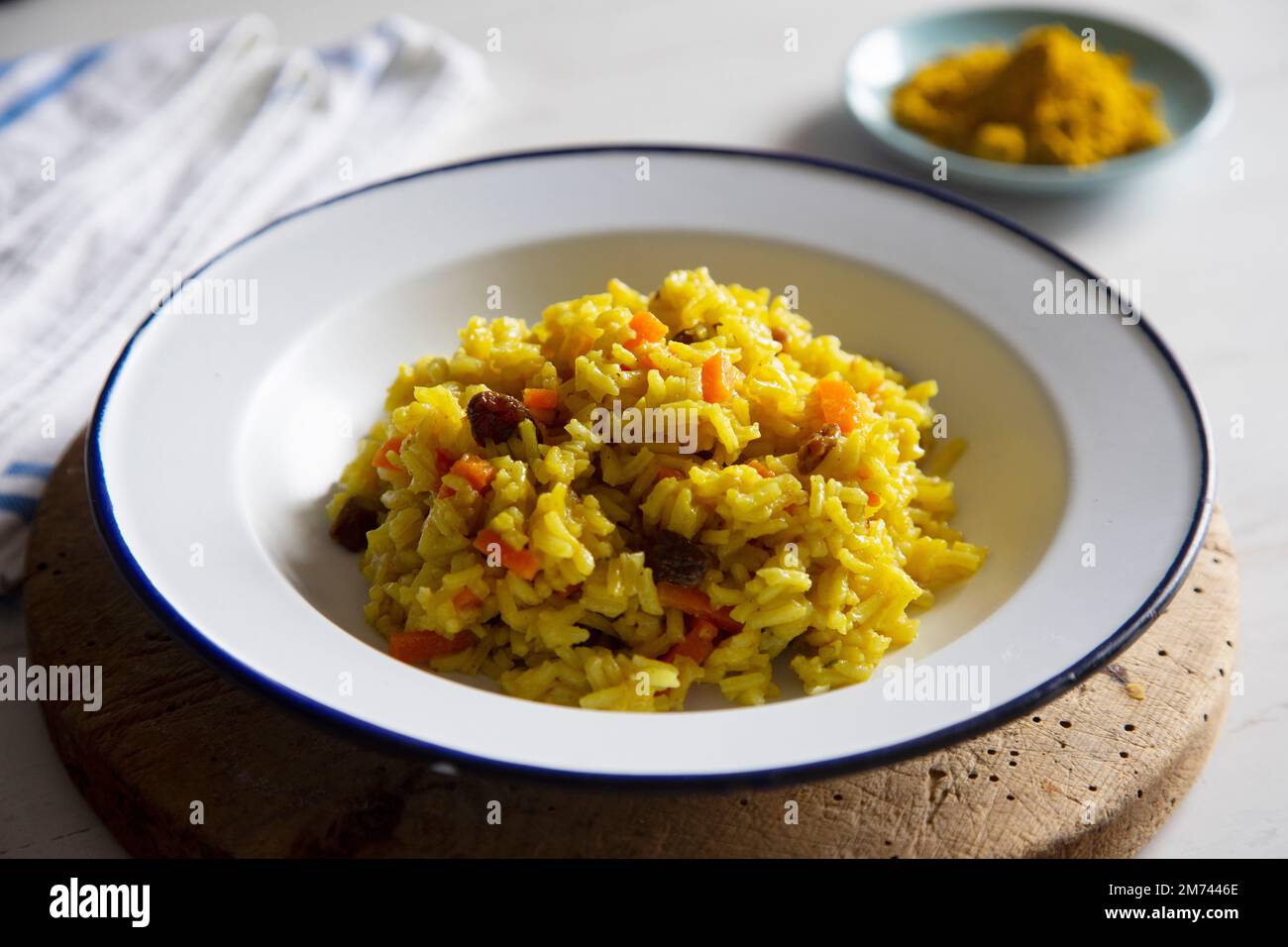 Fried rice cooked with curry, raisins and carrot Stock Photo - Alamy