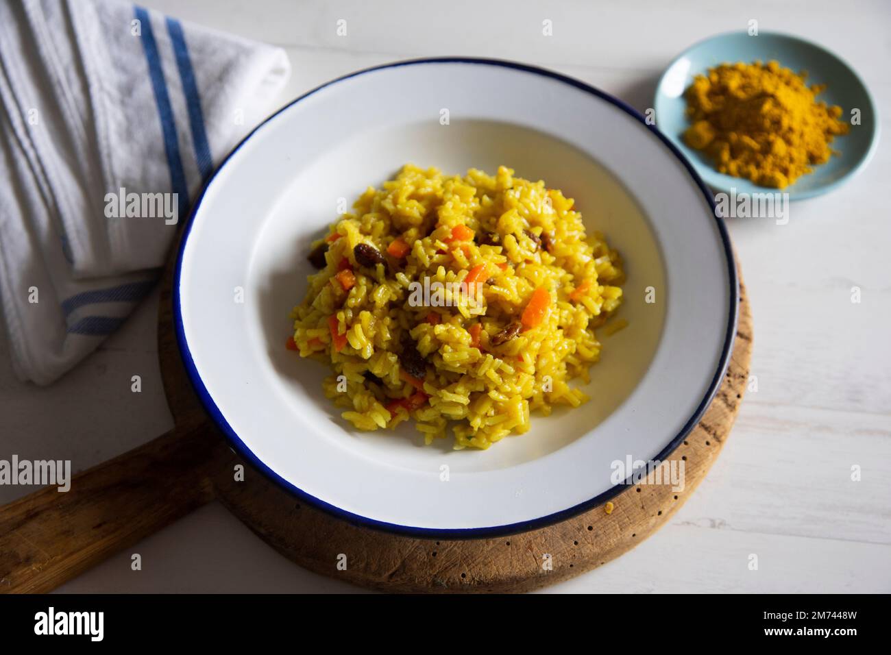 Fried rice cooked with curry, raisins and carrot Stock Photo - Alamy