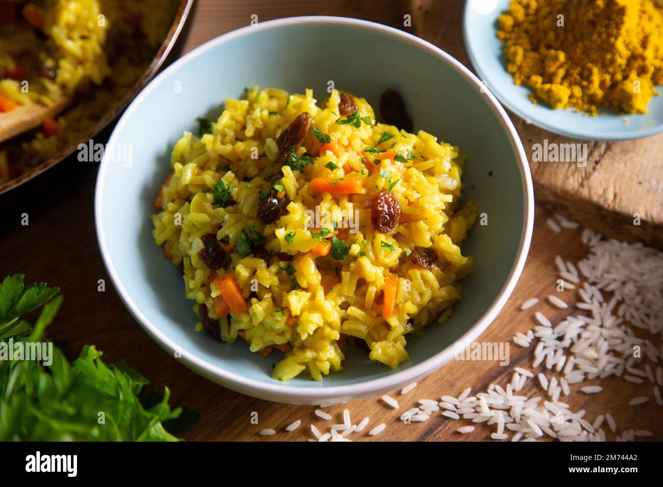 Fried rice cooked with curry, raisins and carrot Stock Photo - Alamy