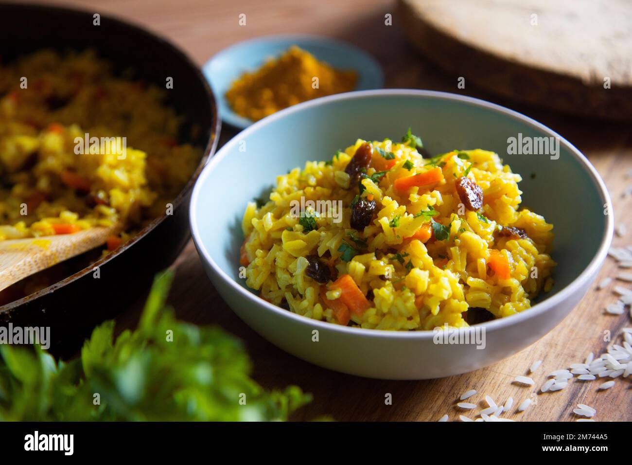 Fried rice cooked with curry, raisins and carrot Stock Photo - Alamy