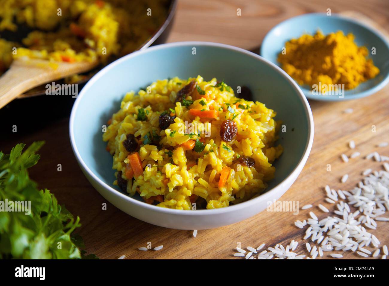 Fried rice cooked with curry, raisins and carrot Stock Photo - Alamy