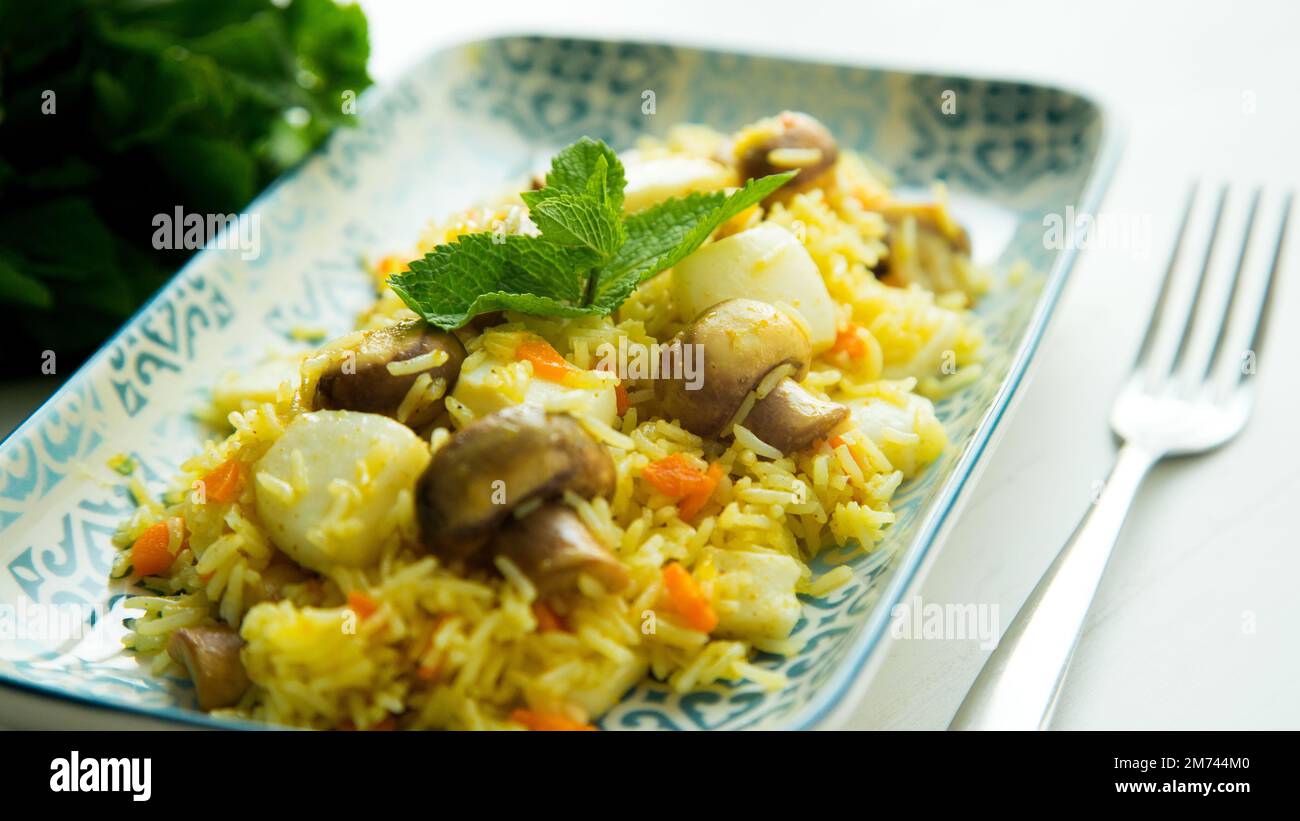 Fried rice with curry, vegetables and cuttlefish Stock Photo - Alamy