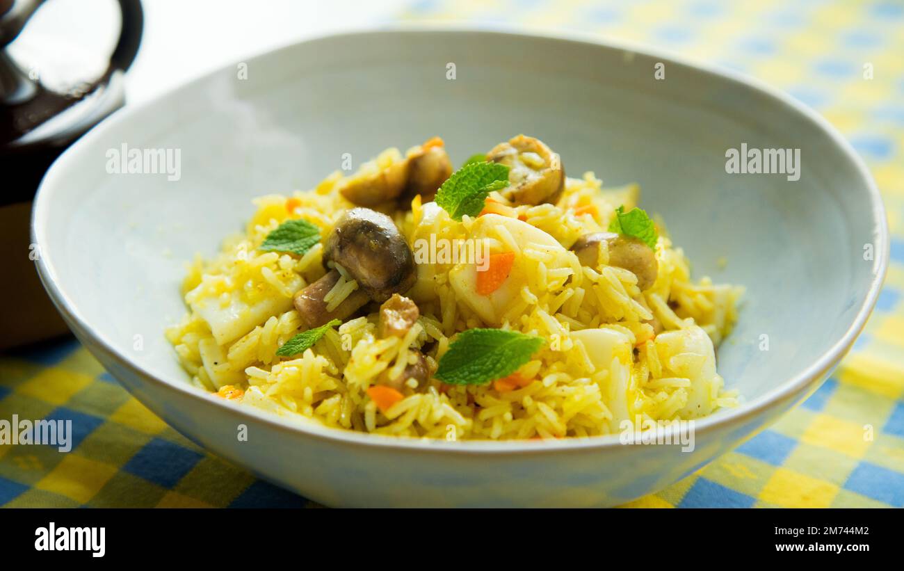 Fried rice with curry, vegetables and cuttlefish Stock Photo - Alamy