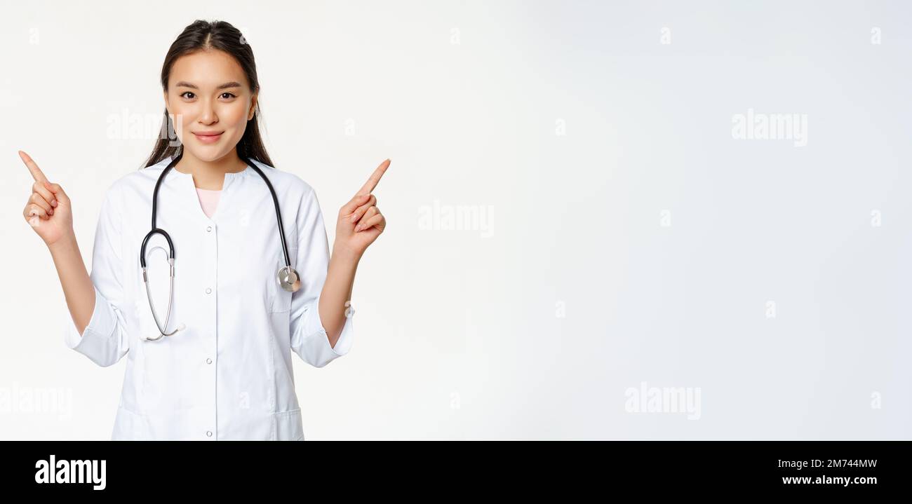 Portrait of asian female doctor, young healthcare worker in medical ...