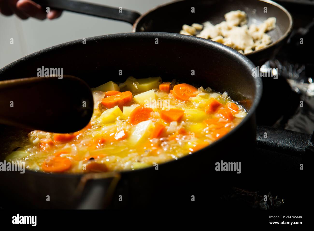 Preparing curry sauce with carrots, onion and other vegetables Stock ...