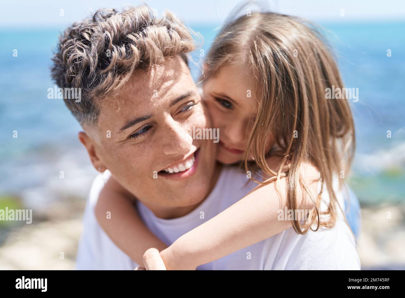 Father And Daughter Smiling Confident Hugging Each Other Holding On