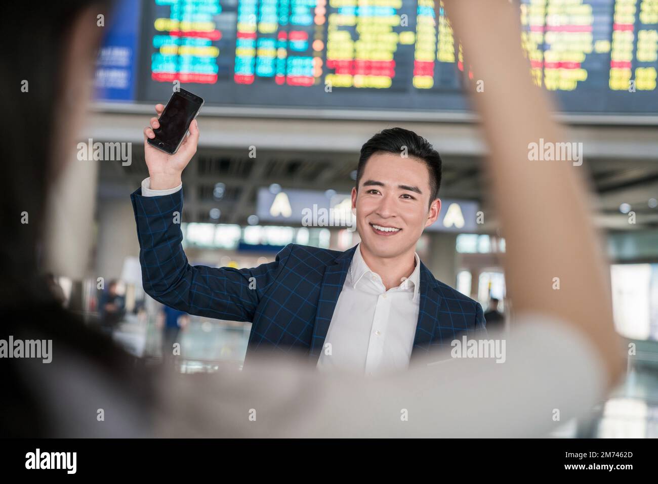 Young couple reunited at the airport Stock Photo - Alamy