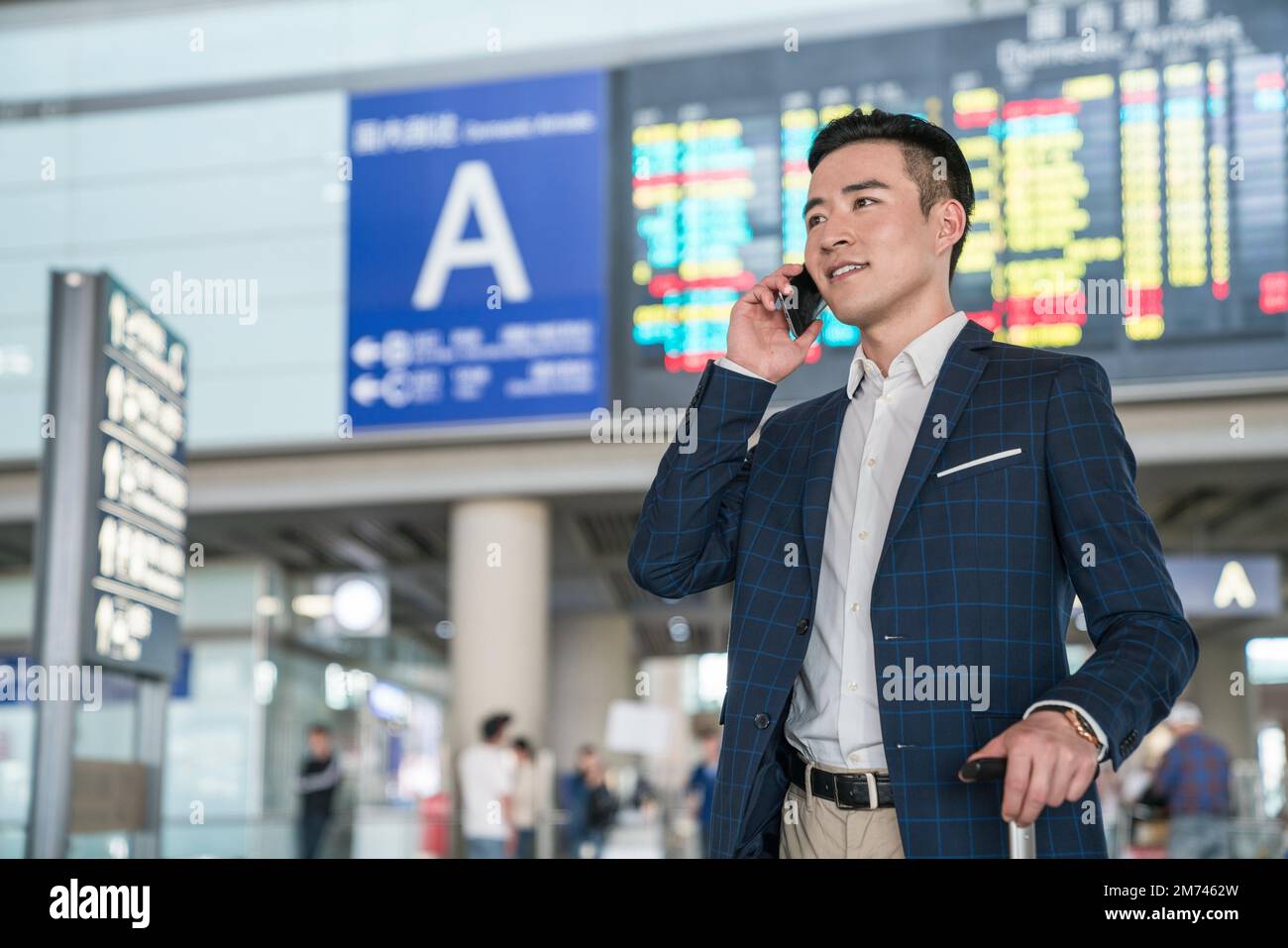 A young business man make a phone call at the airport Stock Photo - Alamy
