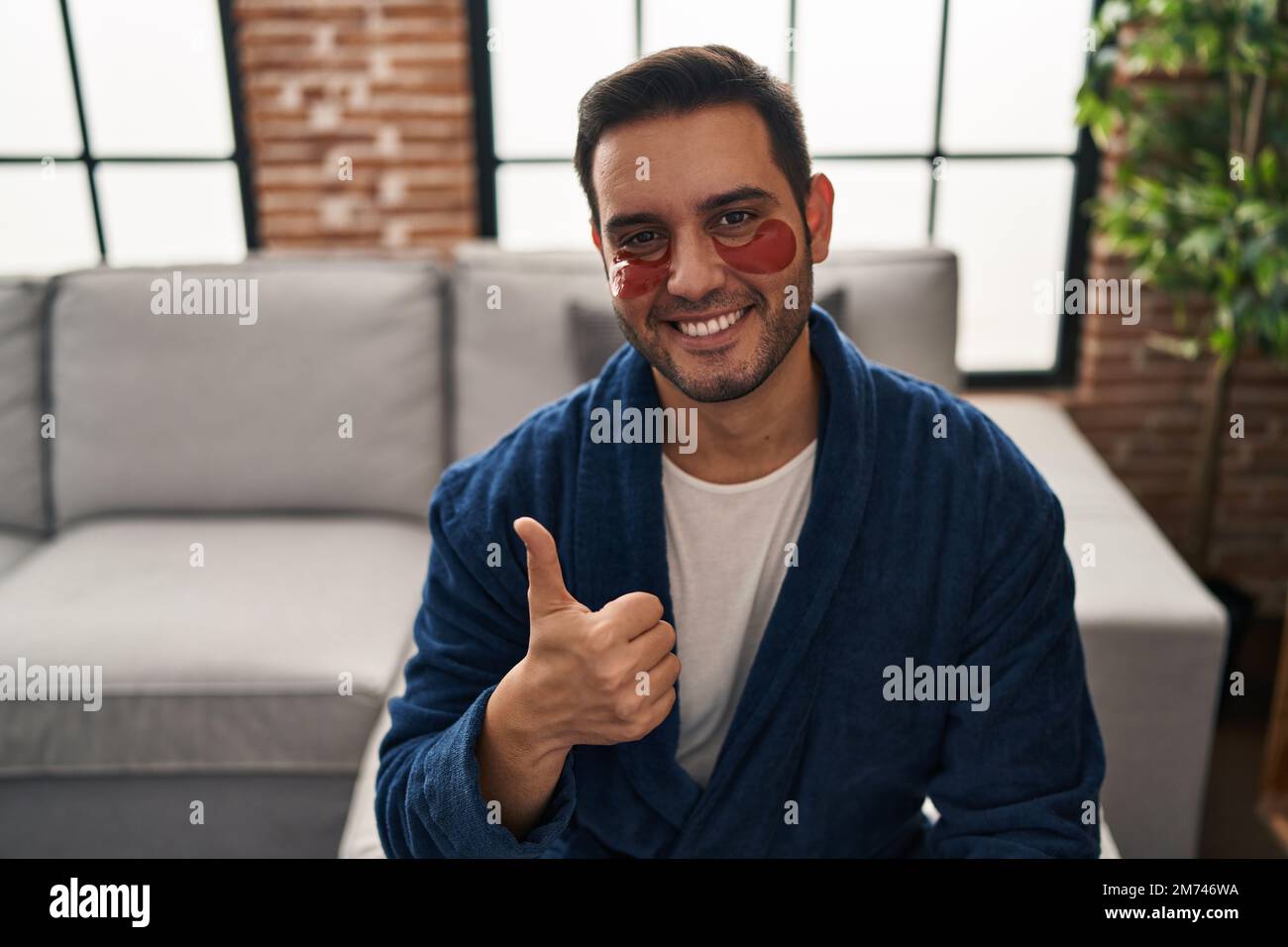 Young hispanic man with beard wearing beauty eyes patch smiling happy ...