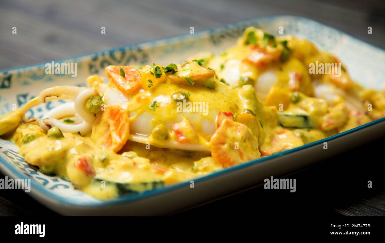 Cuttlefish with curry sauce and vegetables Stock Photo - Alamy