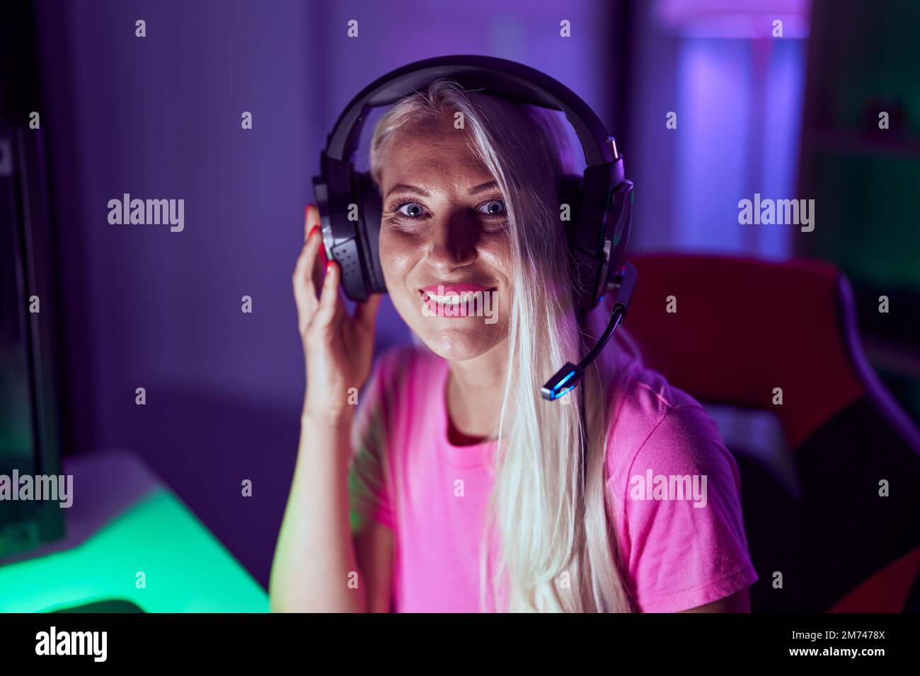 Young blonde woman streamer smiling confident using headphones at ...