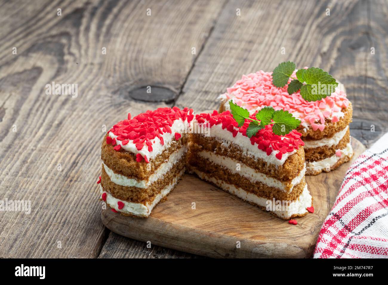 Homemade layered dessert with whipped cream and heart shaped sprinkles ...