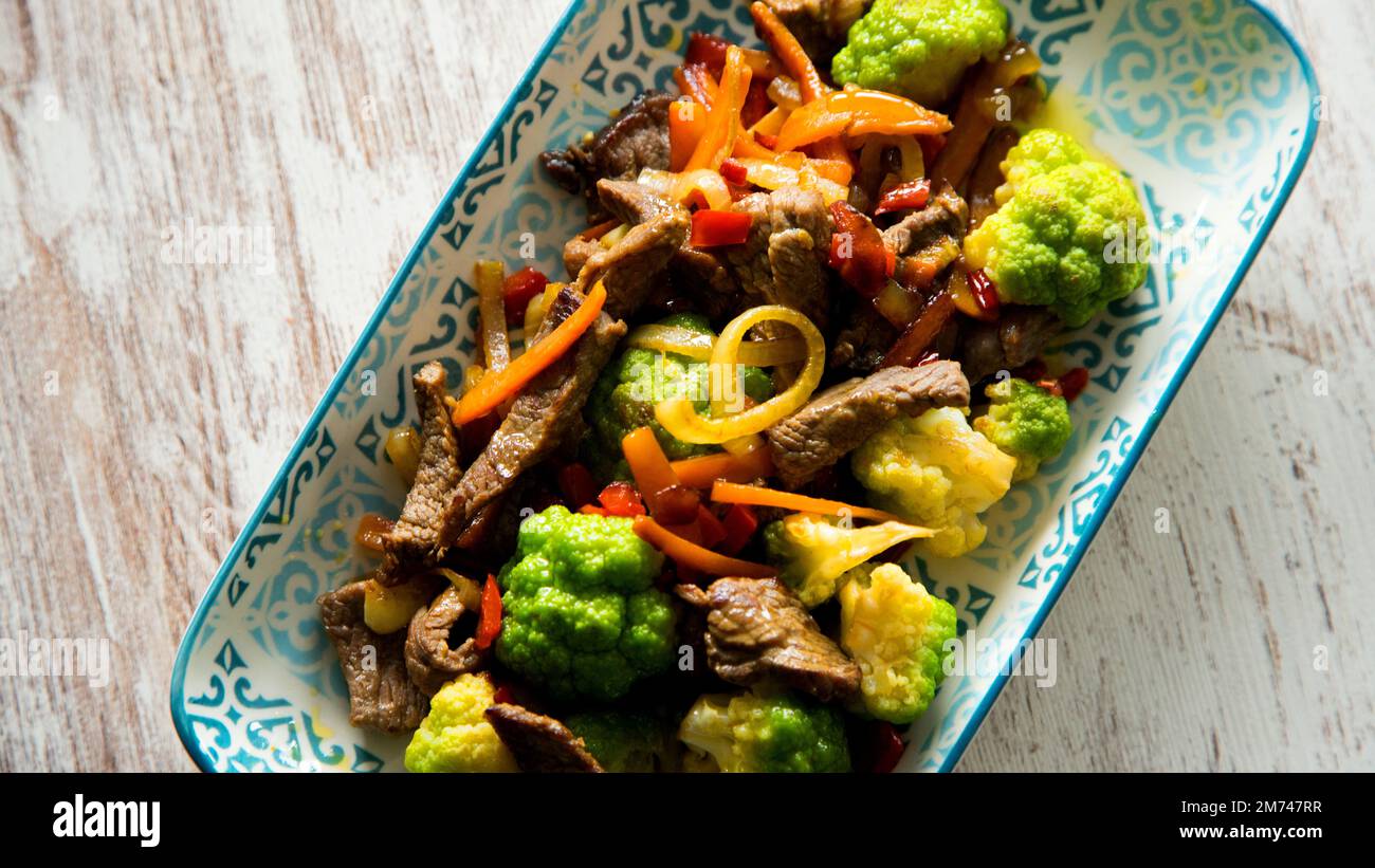 Dish with beef and vegetables like carrot and green broccoli Stock ...