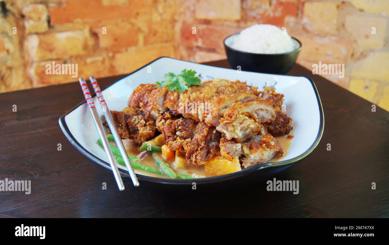 Dish with crispy duck in a restaurant in Tokyo. Asian combo plate with ...