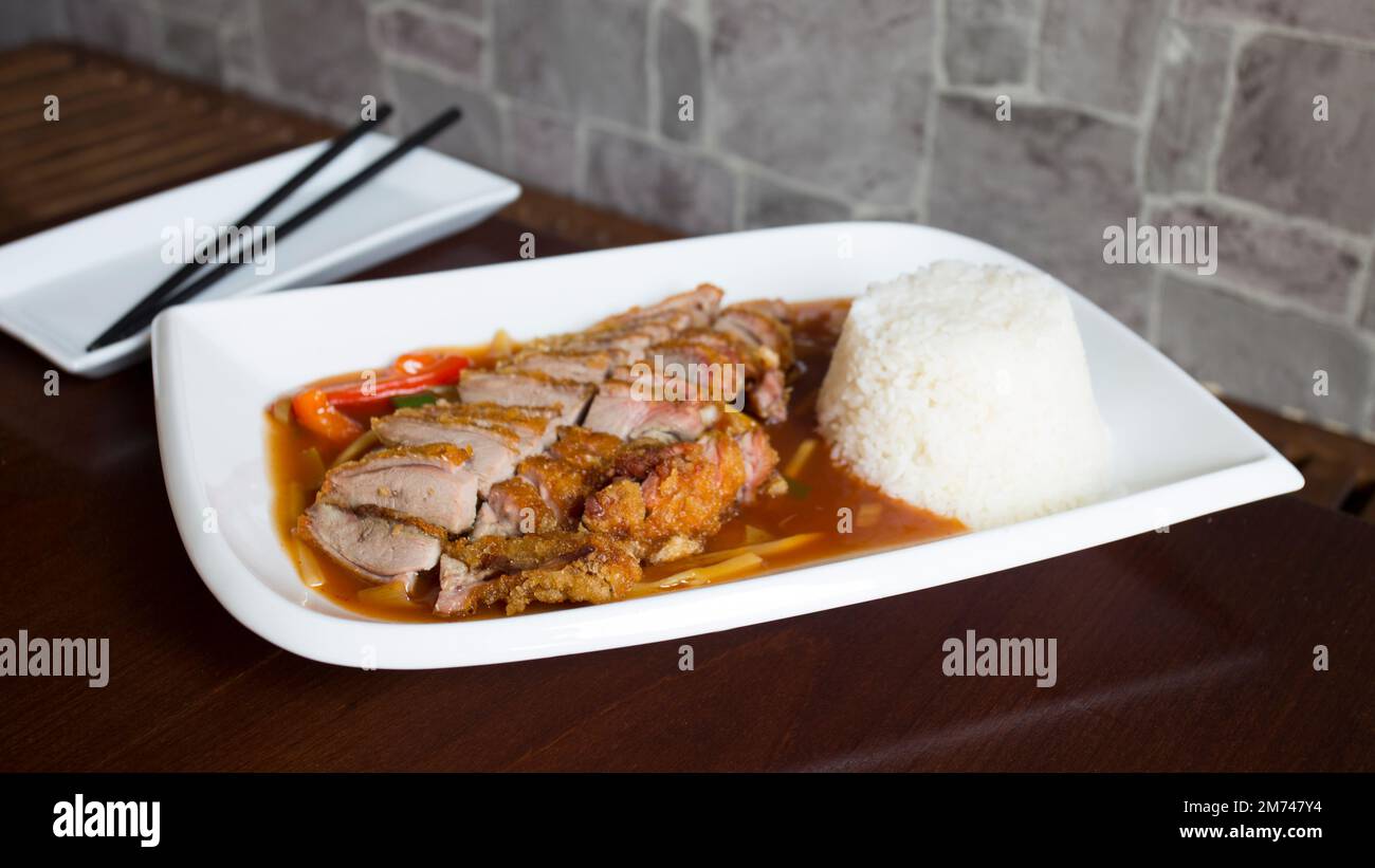 Dish with crispy duck in a restaurant in Tokyo. Asian combo plate with ...