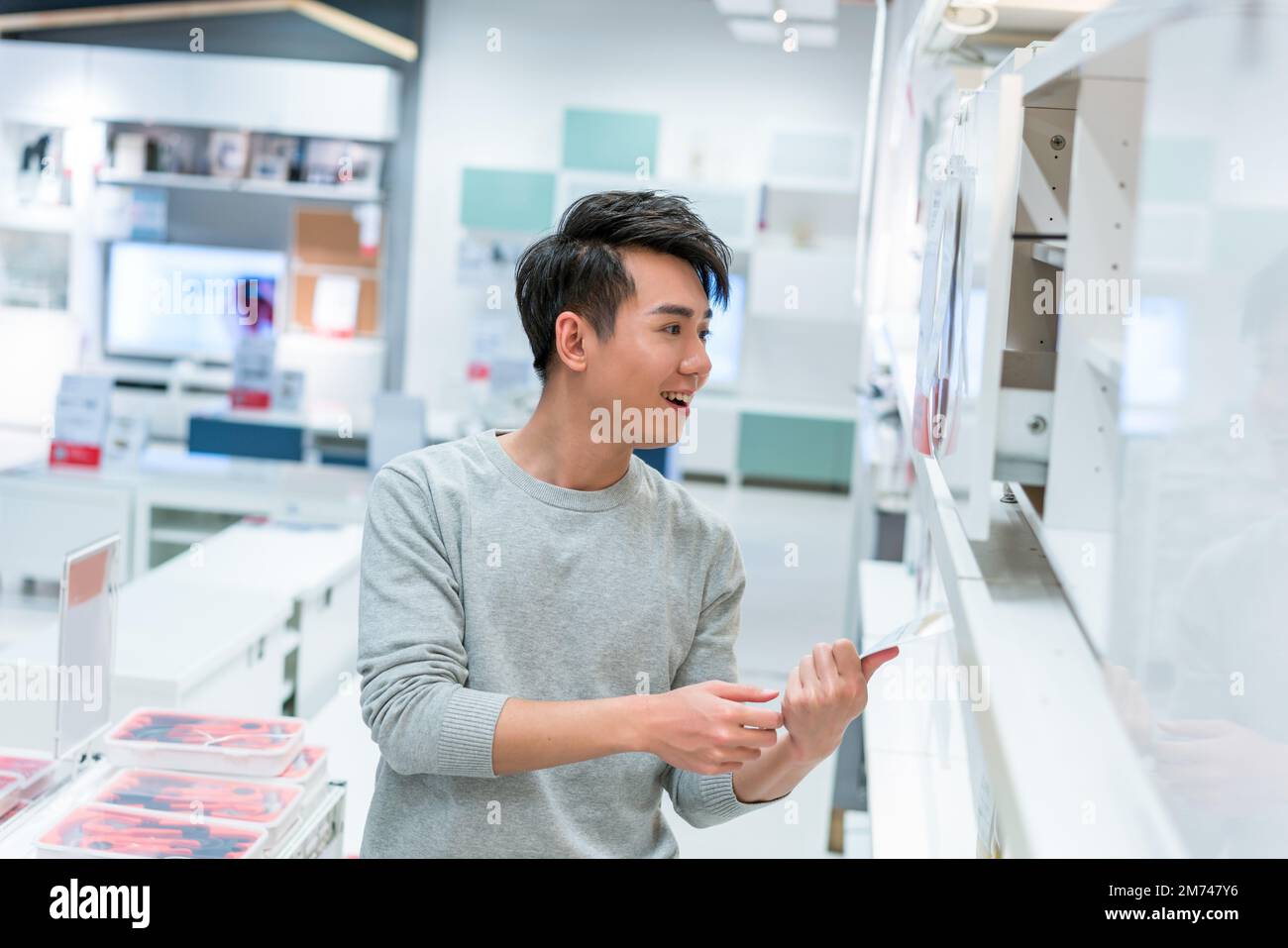 Young men choose furniture Stock Photo - Alamy