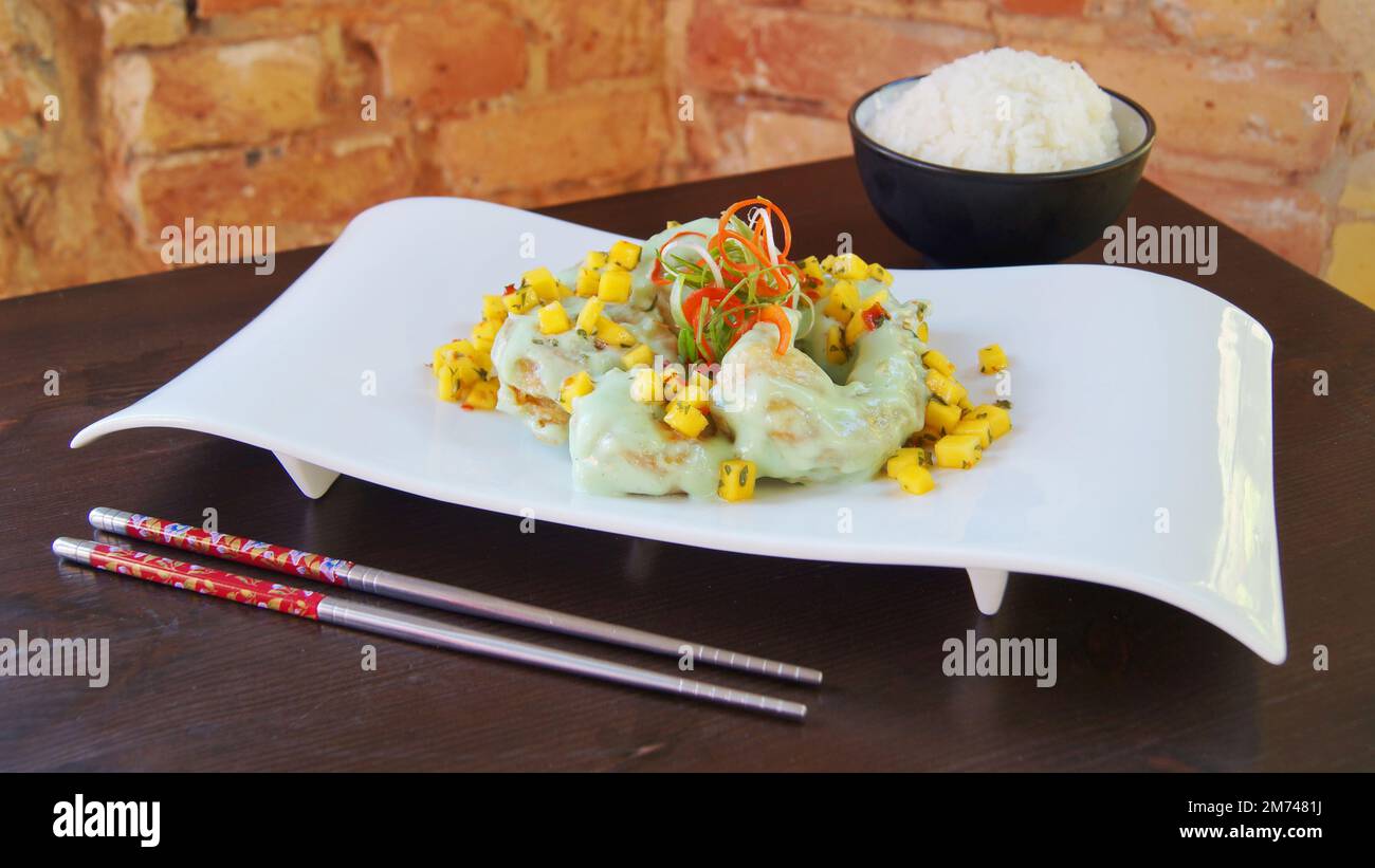 Asian combo plate with fish served with rice or noddles. Dish with ...