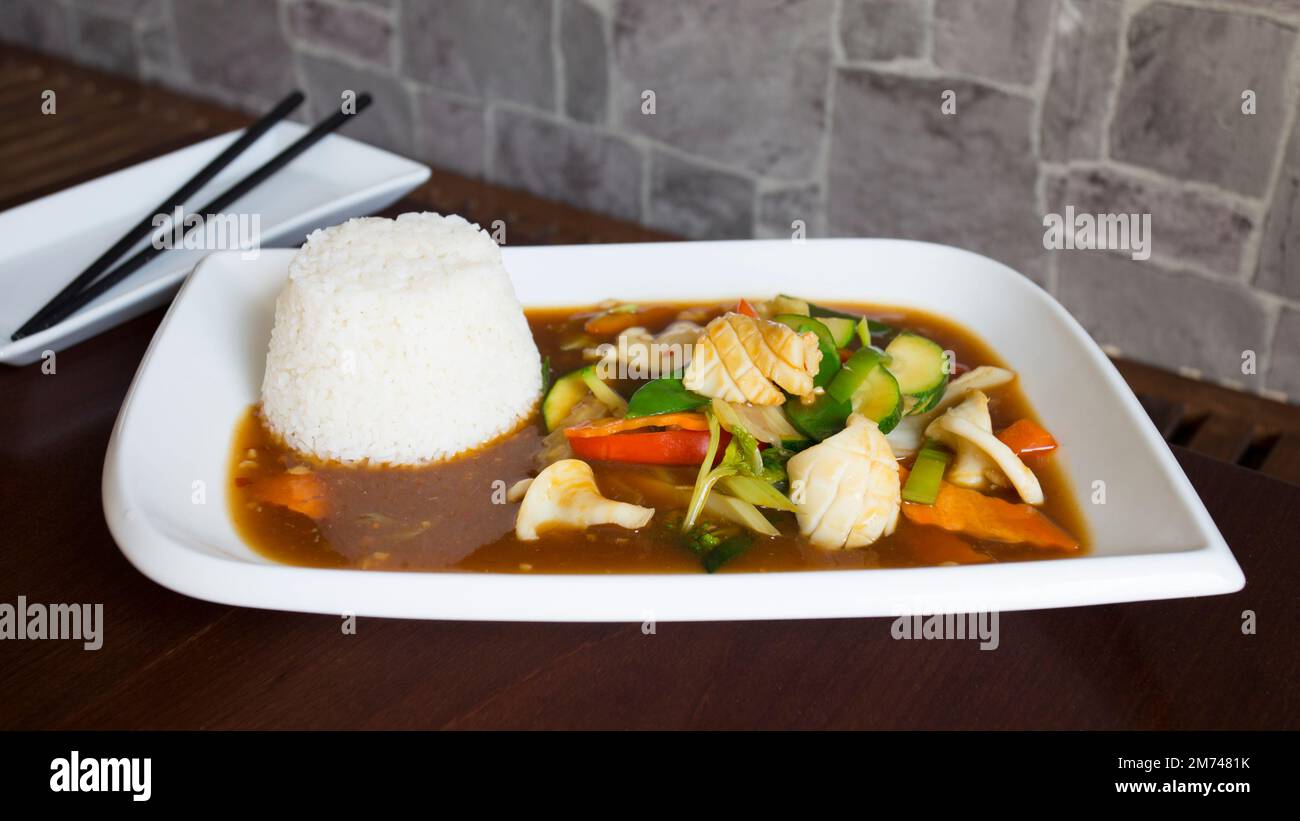Asian combo plate with fish served with rice or noddles. Dish with ...