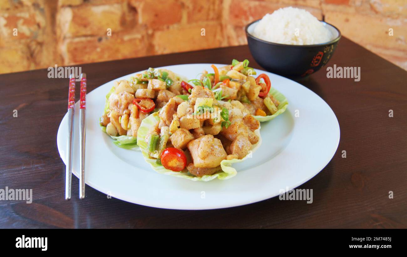 Asian combo plate with chicken cooked with vegetables Stock Photo - Alamy
