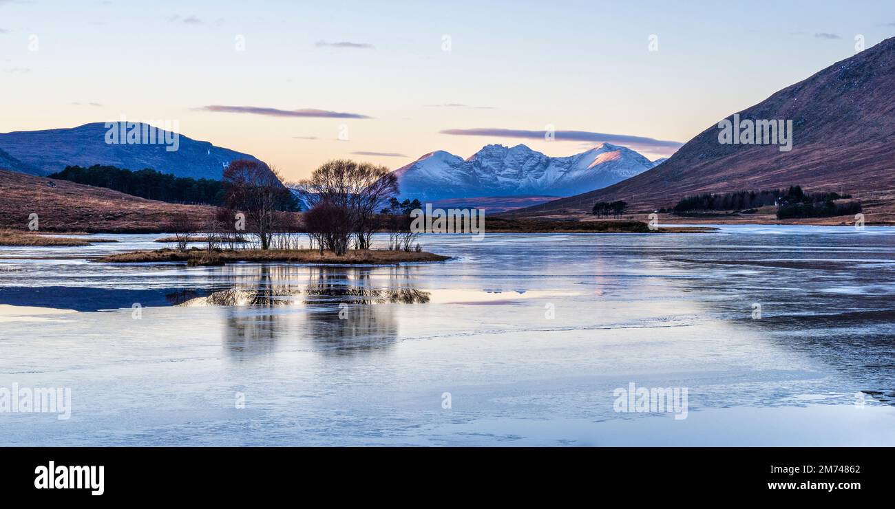 Frozen Loch Droma, with the towering heights of An Teallach mountain ...