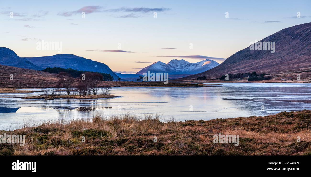 Frozen Loch Droma, with the towering heights of An Teallach mountain ...