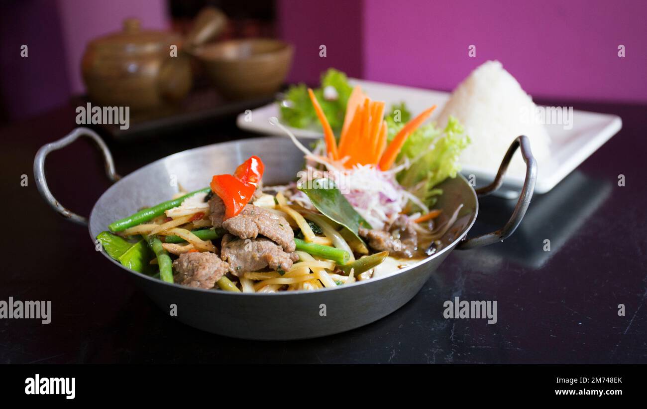 Asian combo plate with beef in curry sauce and vegetables served with ...
