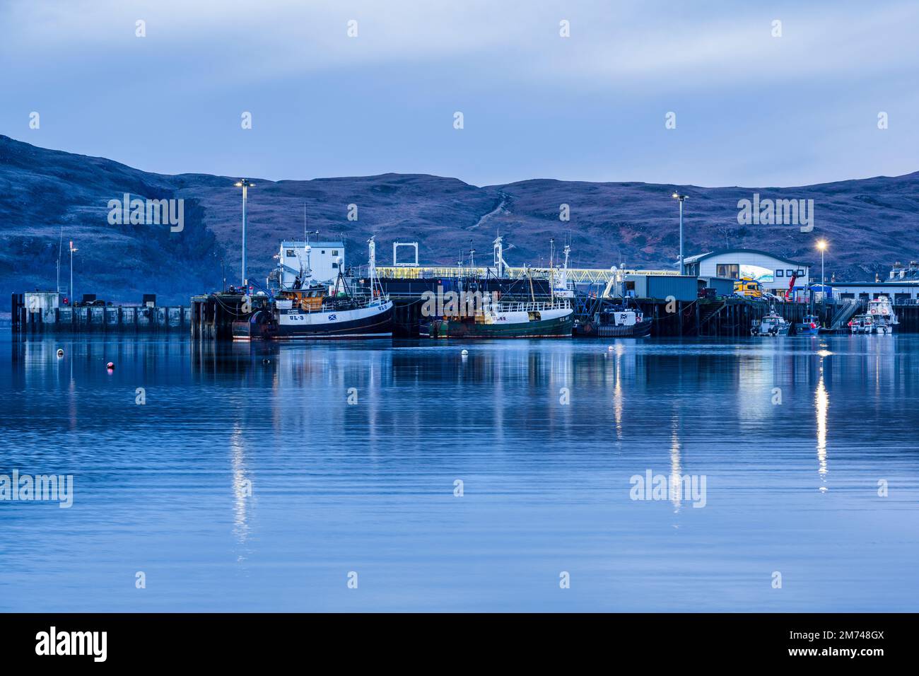 Fishing boats moored at Ullapool pier at daybreak - Ullapool, Wester ...