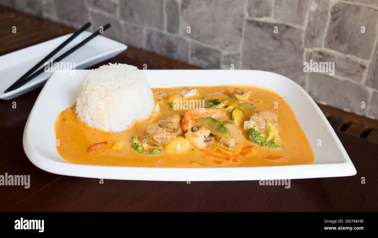 Asian combo plate with beef in curry sauce and vegetables served with ...