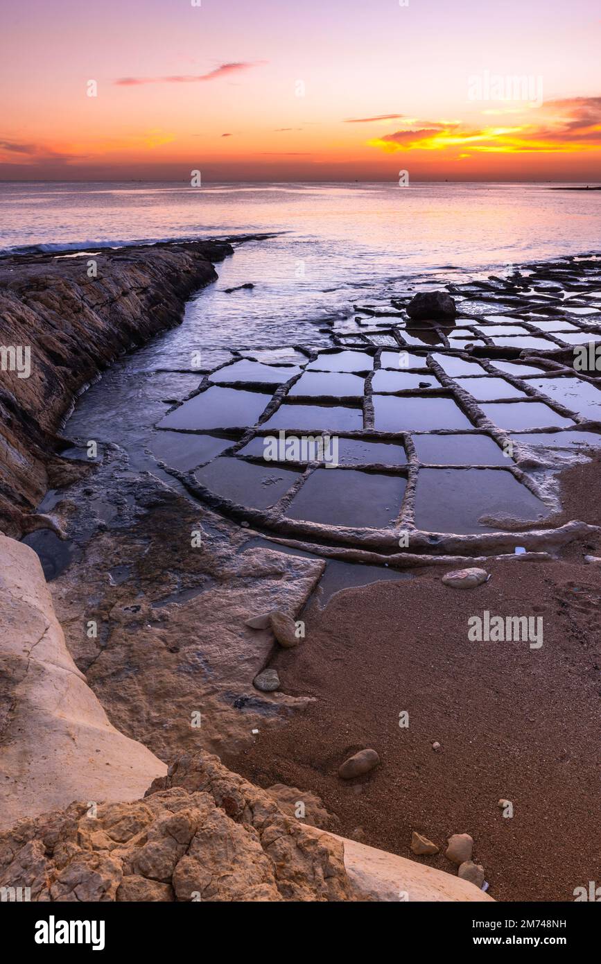 Salt pans at beach in Marsaskala, Malta at sunrise Stock Photo - Alamy