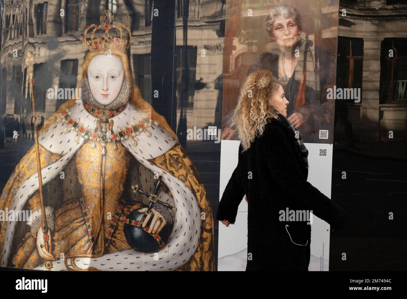 A member of the public walks past reproductions of Queen Elizabeth I ...