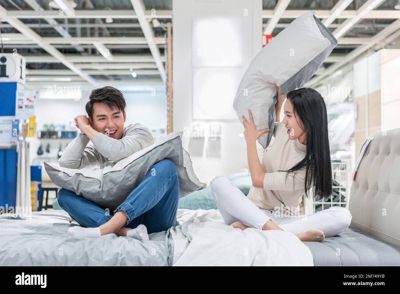 Sweet young lovers in bed pillow fight Stock Photo - Alamy