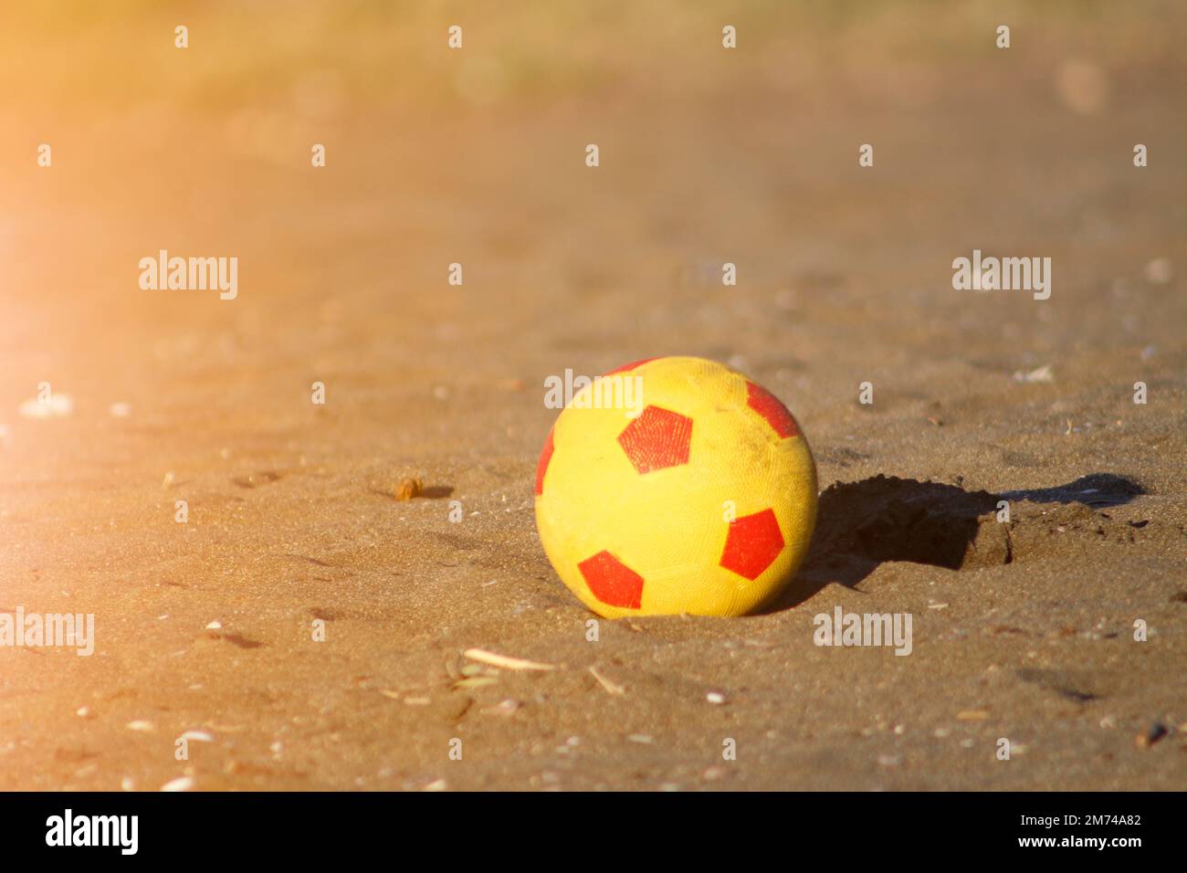 Beach landscape with a soccer ball on the sand under a summer sun Stock ...