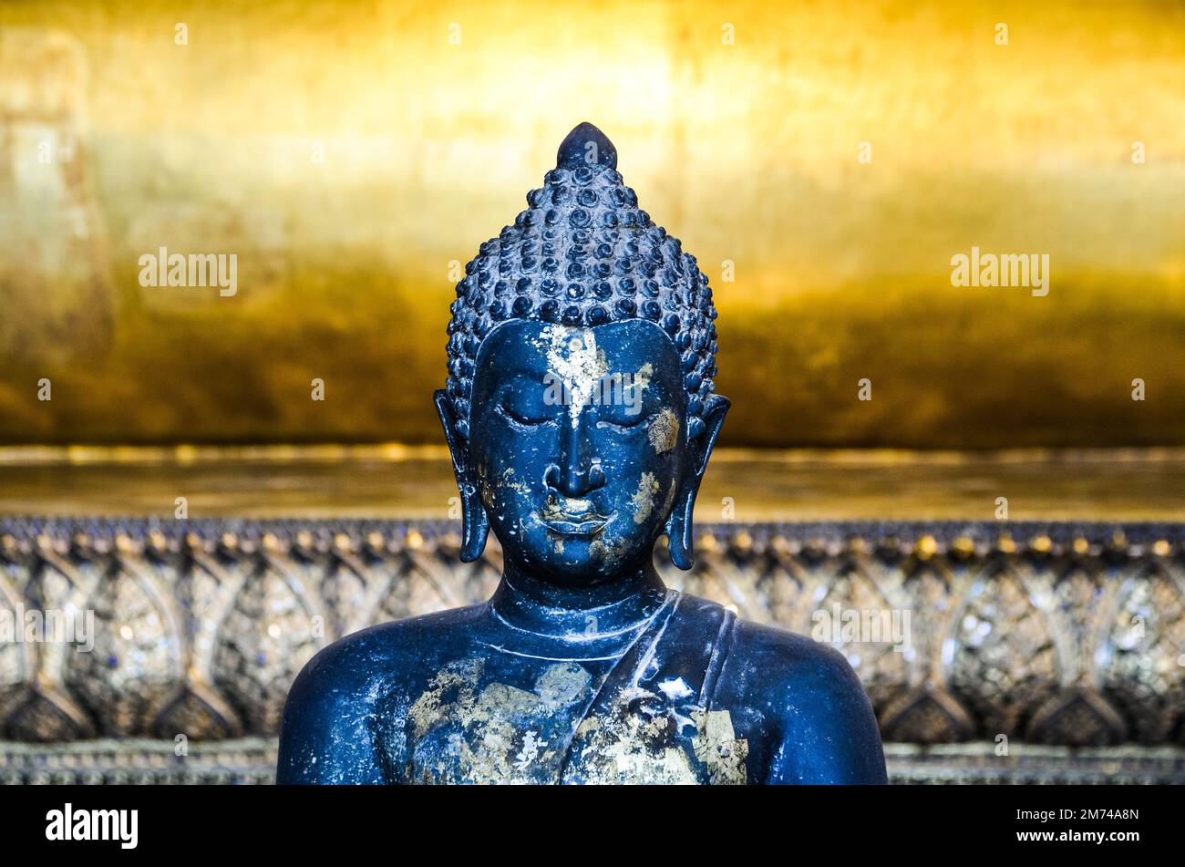 A close-up shot of a blue statue of Buddha in a temple Stock Photo - Alamy