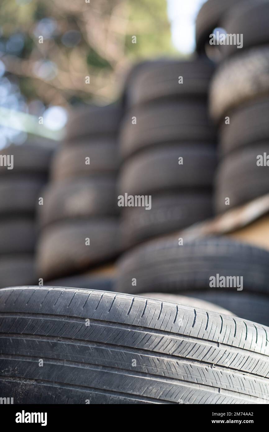 Old used rubber tires stacked with high piles. Hazardous waste ...