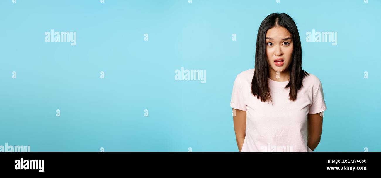 Image of asian korean girl look surprised, raising eyebrows confused ...