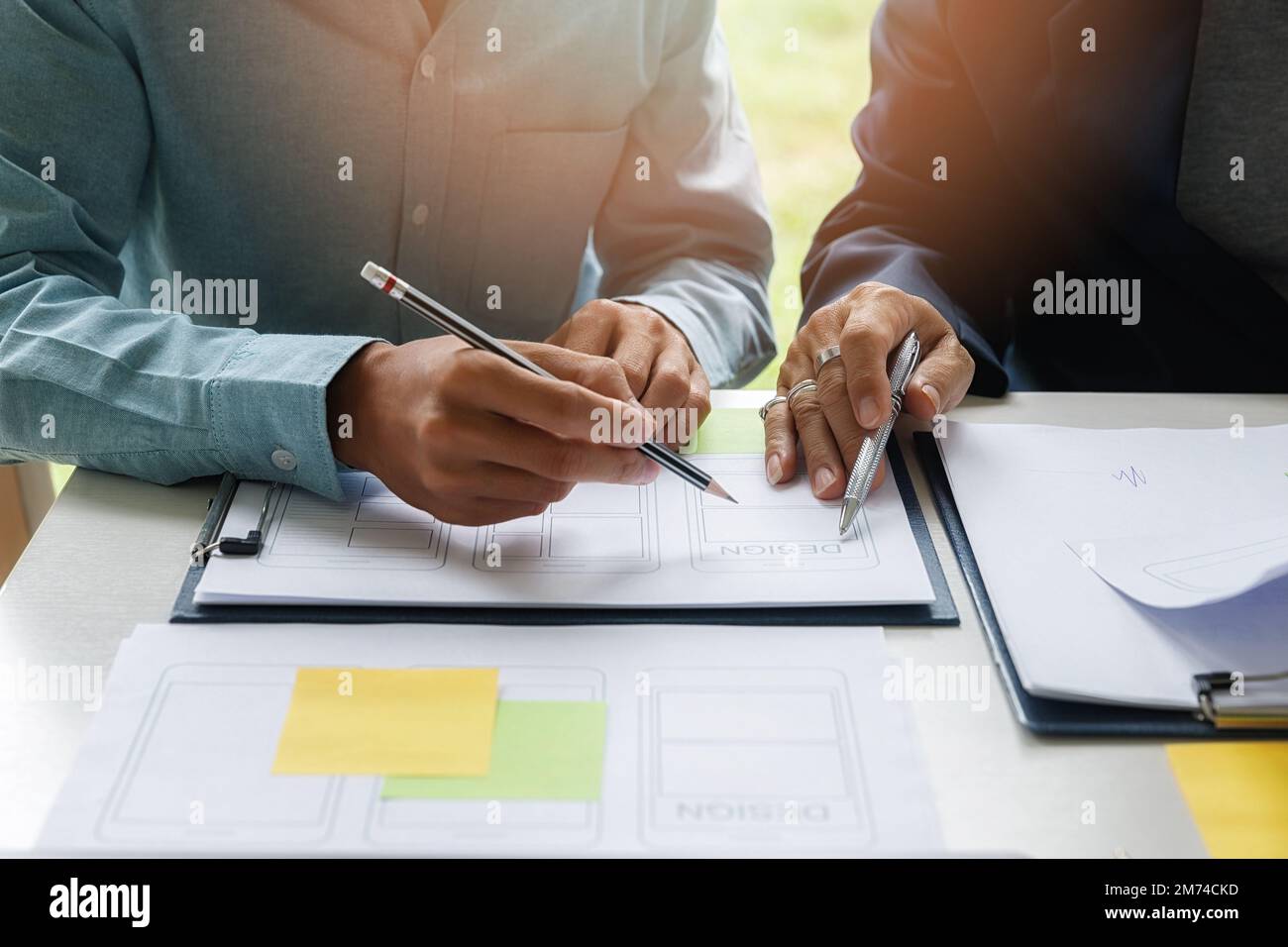 UX or UI designers designing on their smartphone application layout ...