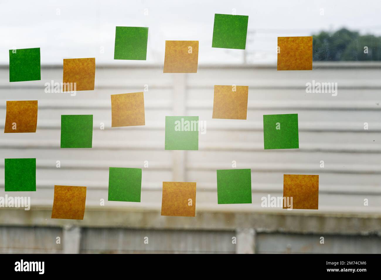 Blank Sticky notes on a glass of window in the office. Brainstorming ...