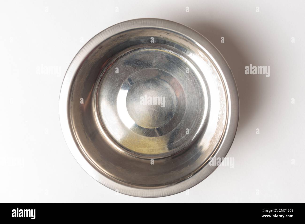 An empty metal bowl for cat and dog food on a white background for ...