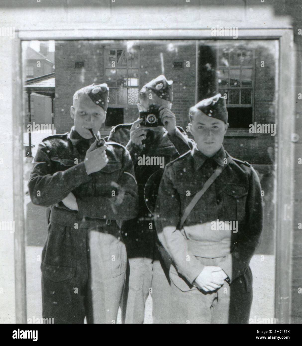 England. 1940s. Three British Army soldiers, serving with the Royal Engineers, are posing for a ...