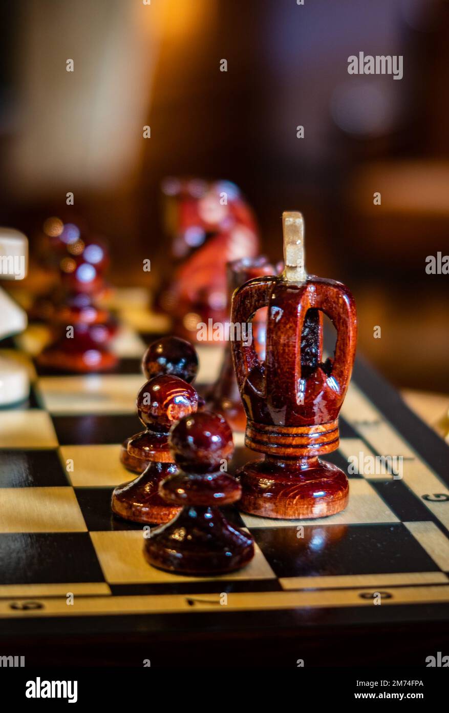 A closeup of a chess board with black figures, blurred background Stock ...