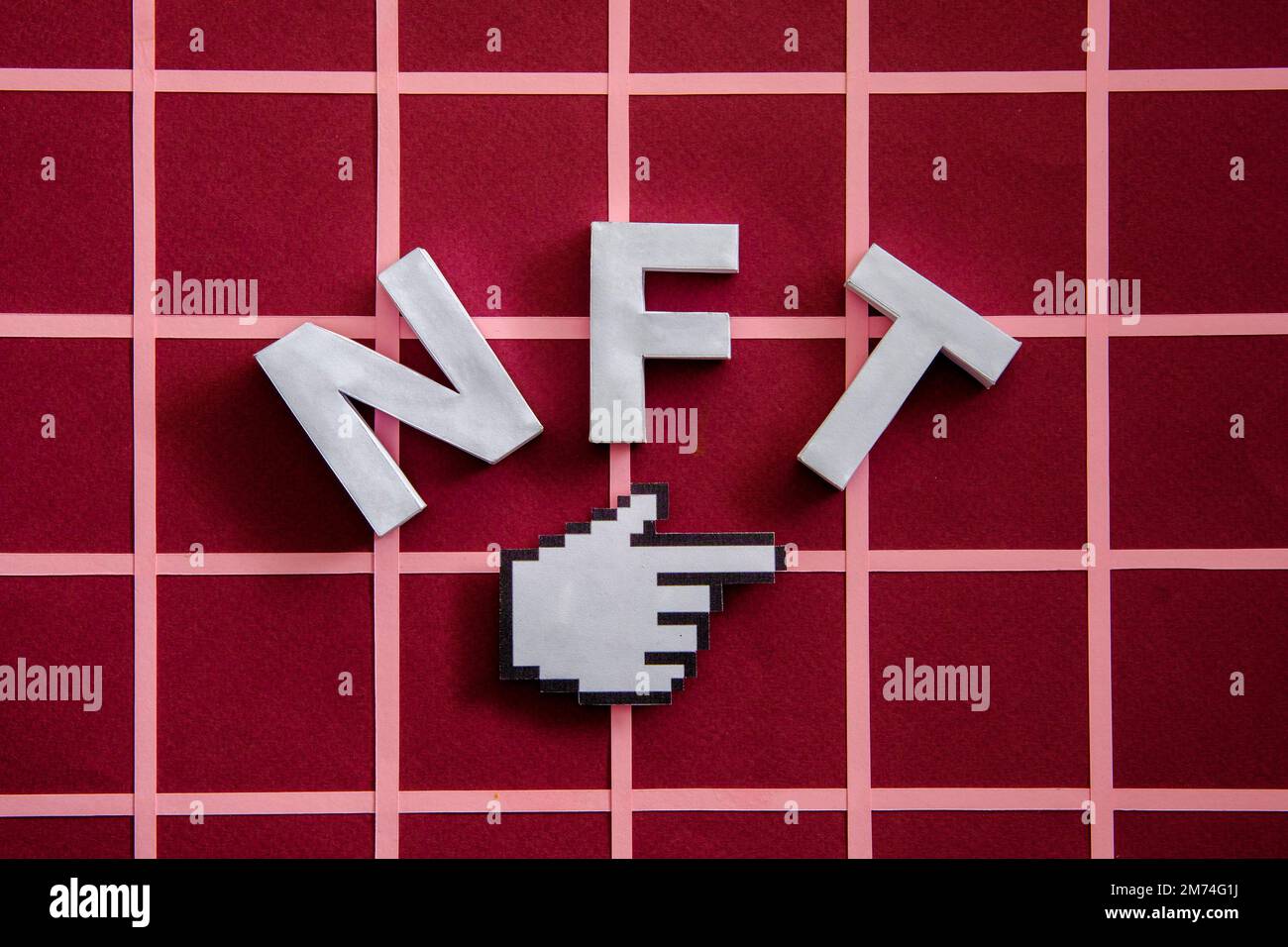 NFT and pixel finger mouse pointer on a red background Stock Photo - Alamy