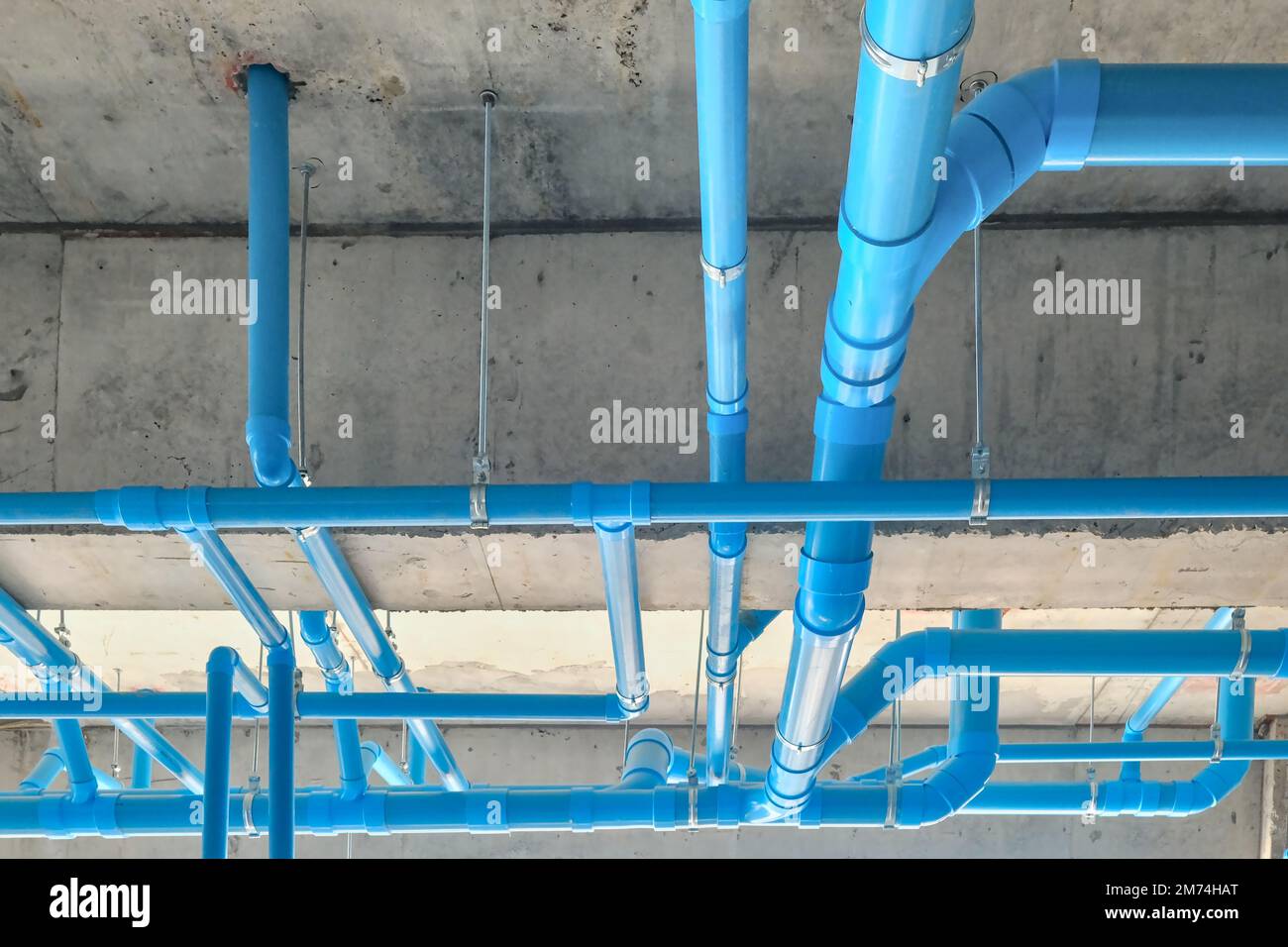 A low angle shot of industrial blue pipes on a ceiling Stock Photo - Alamy