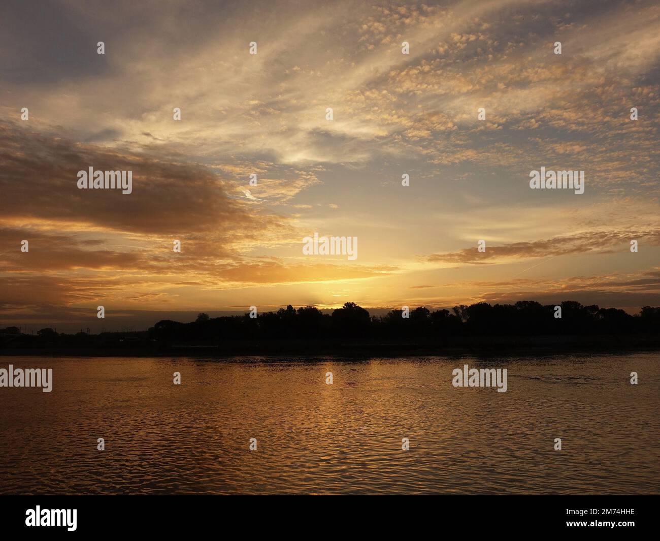 Morning landscape of the river in the light of a rising sun and tiny ...